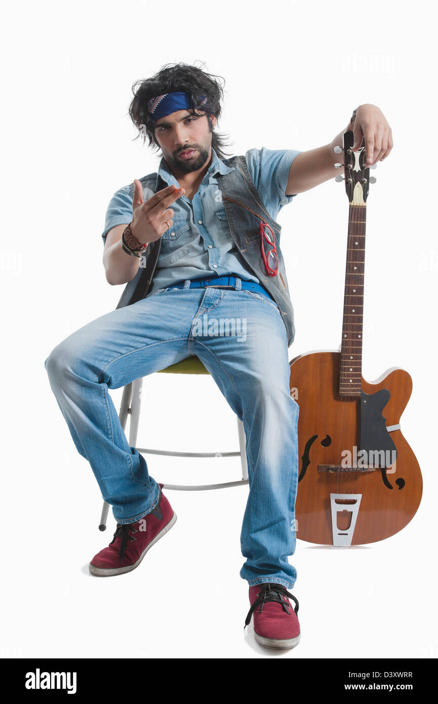 Musician holding a guitar Stock Photo - Alamy