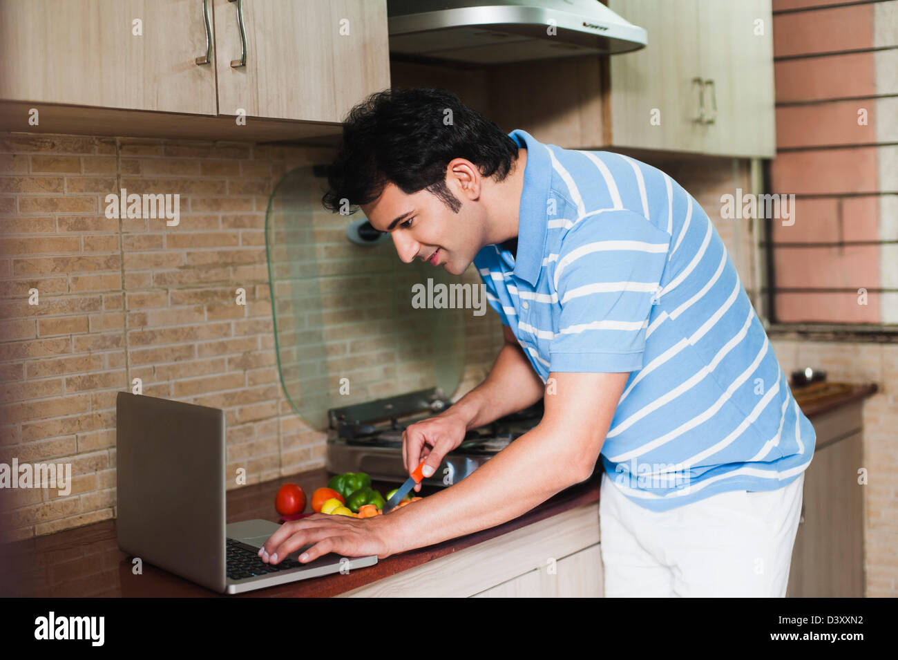 Man cooking in the kitchen Stock Photo - Alamy