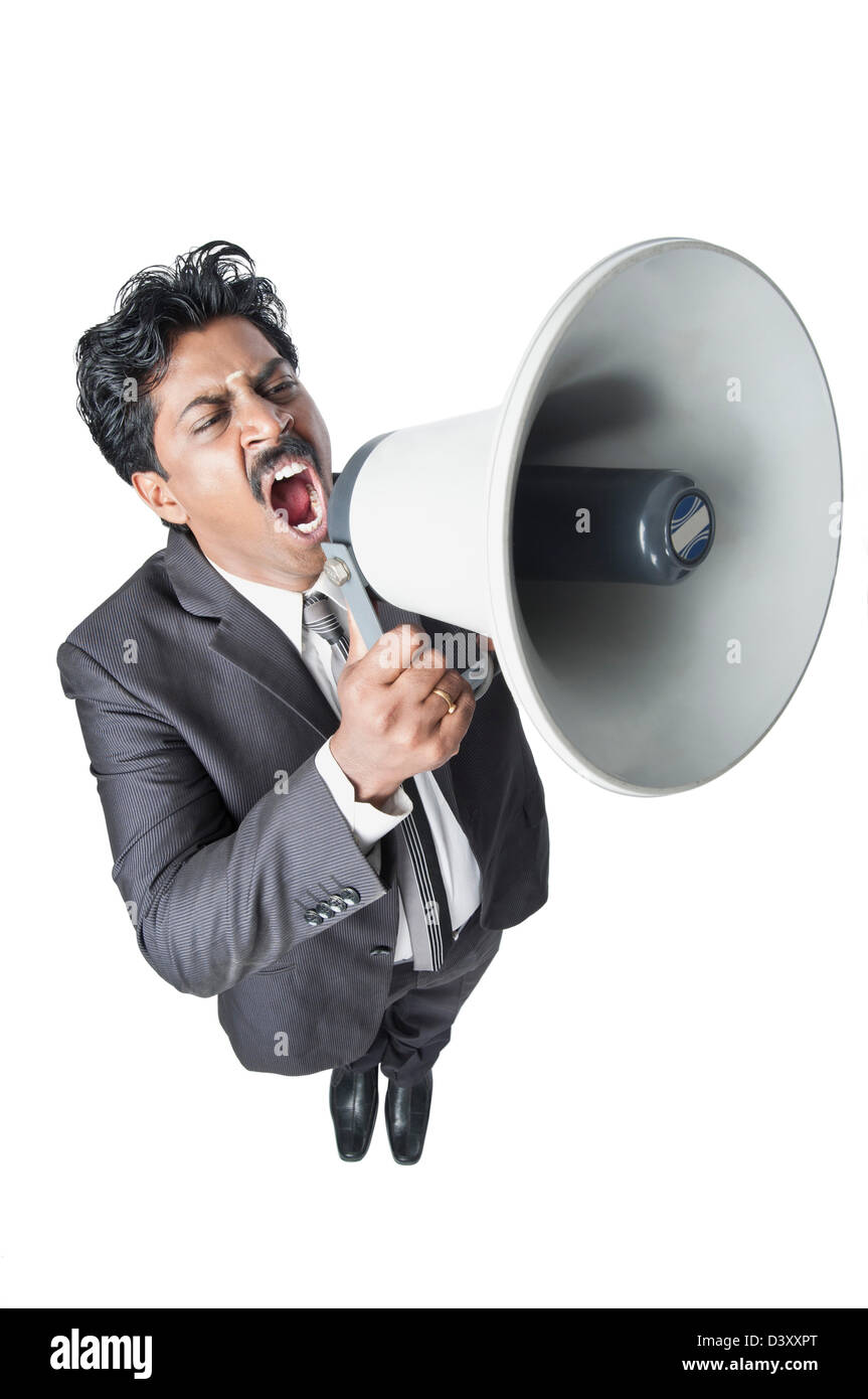 South Indian businessman shouting in a megaphone Stock Photo - Alamy
