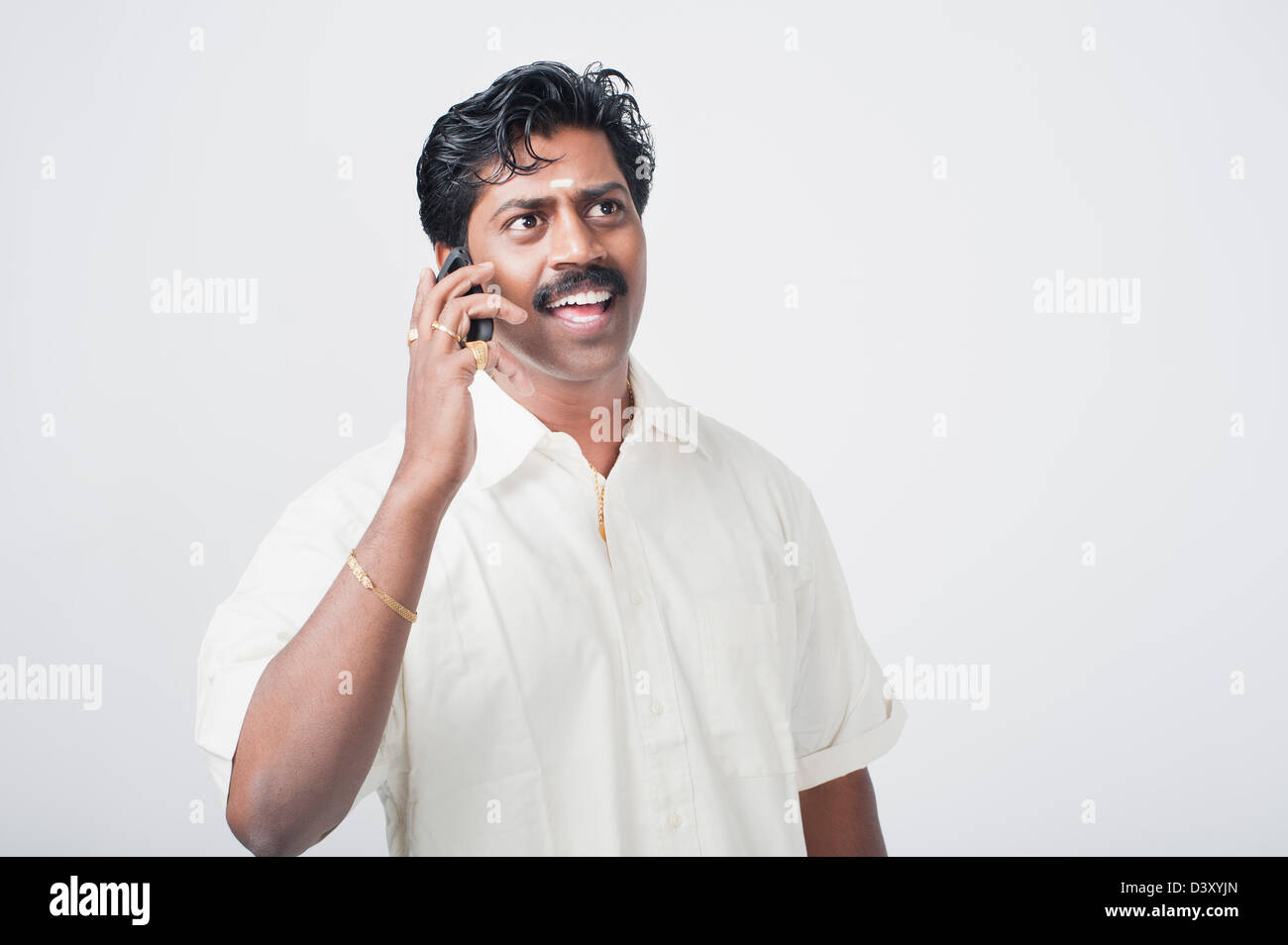 South Indian man talking on a mobile phone Stock Photo - Alamy