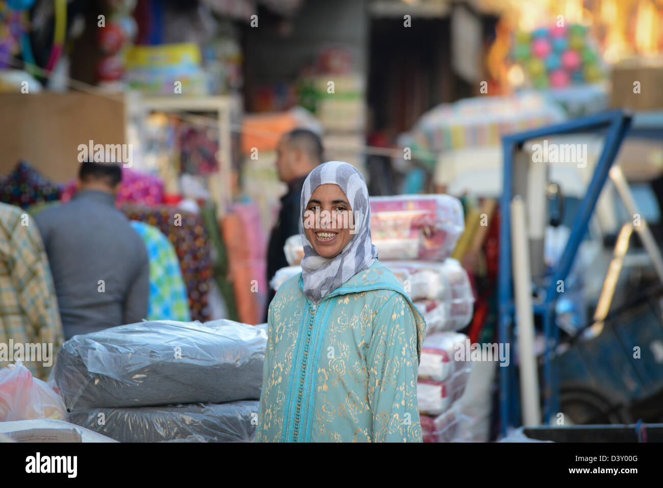 Moroccan woman smiling with the market in the background Stock Photo ...