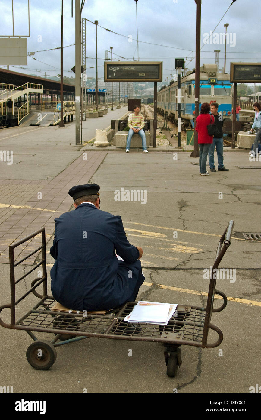 Belgrade station with station porter reading paper hi-res stock ...