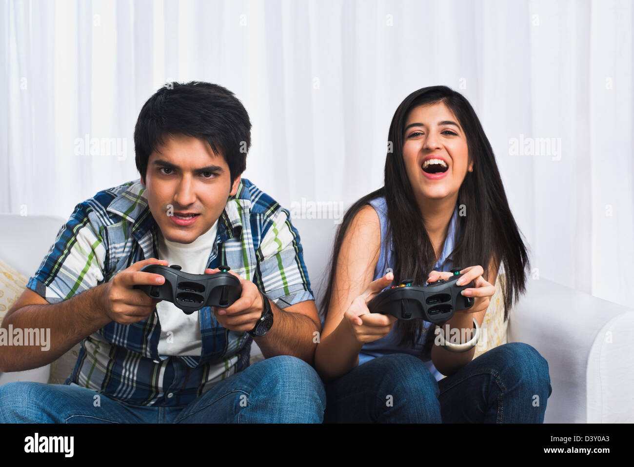 Brother and sister playing video game Stock Photo - Alamy