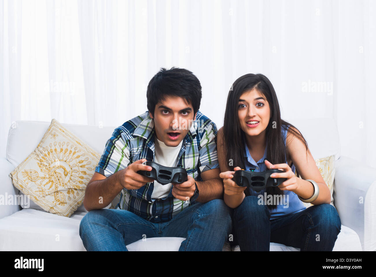 Brother and sister playing video game Stock Photo - Alamy
