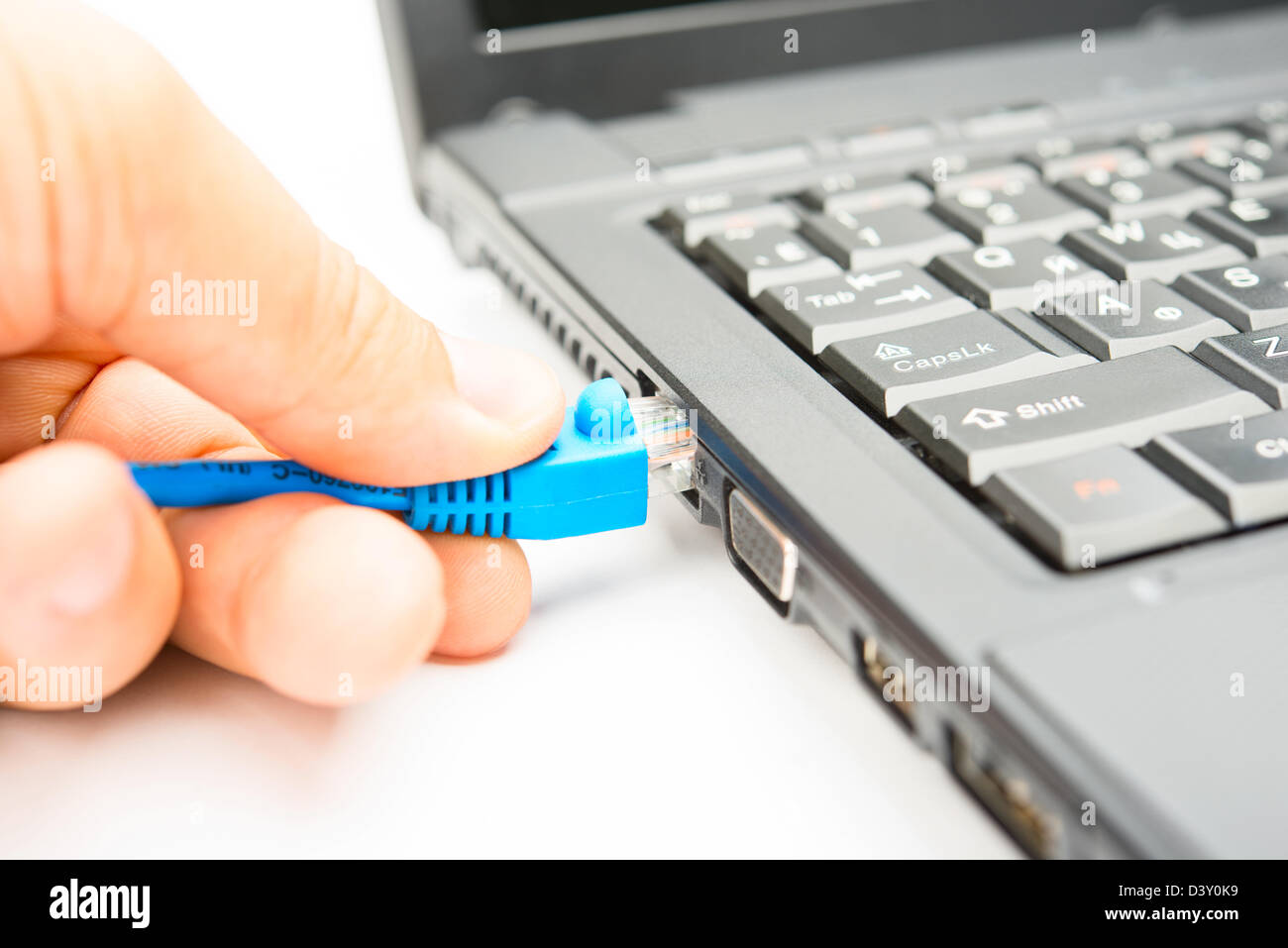 Connecting of internet cable to the notebook Stock Photo - Alamy