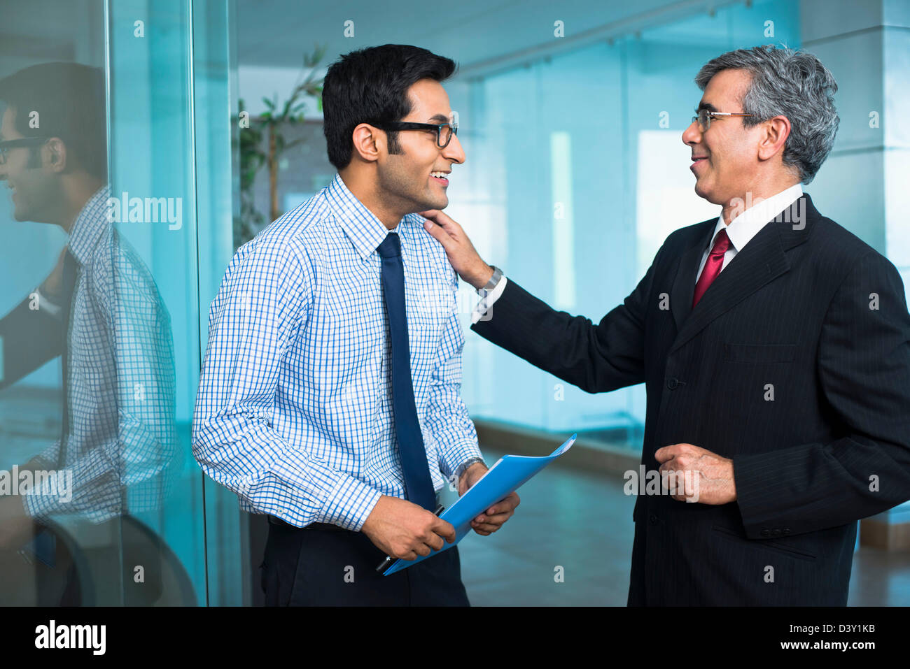 Boss talking with his employee in an office Stock Photo - Alamy