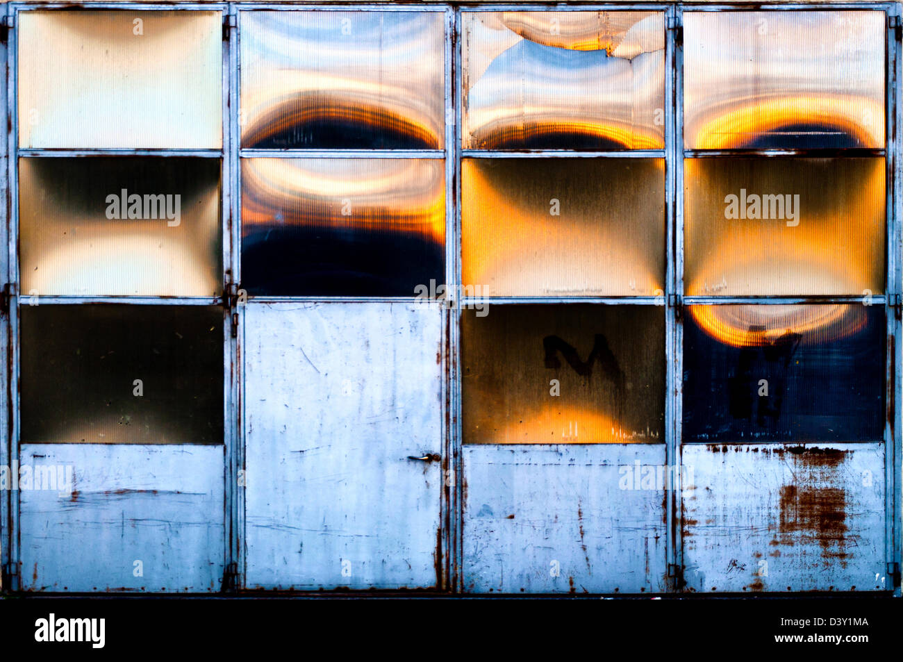Old metal and glass warehouse door with sun reflections Stock Photo - Alamy