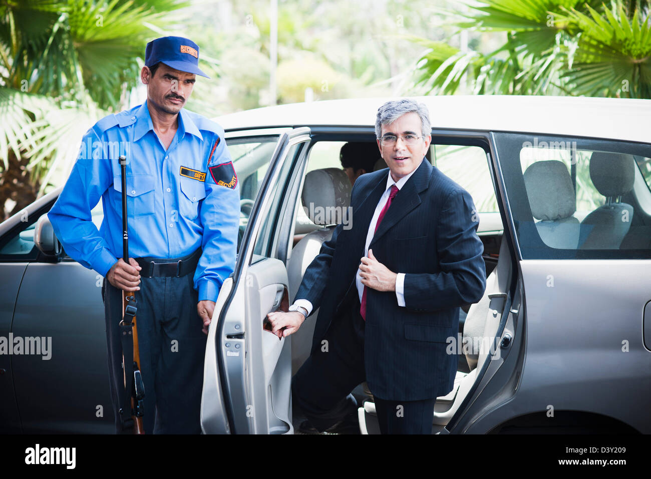 Security guard opening car door for a businessman Stock Photo - Alamy