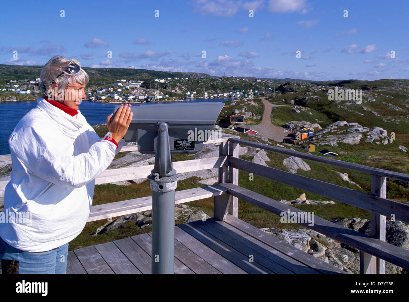 Woman looking through a Telescope at Rose Blanche Lighthouse ...