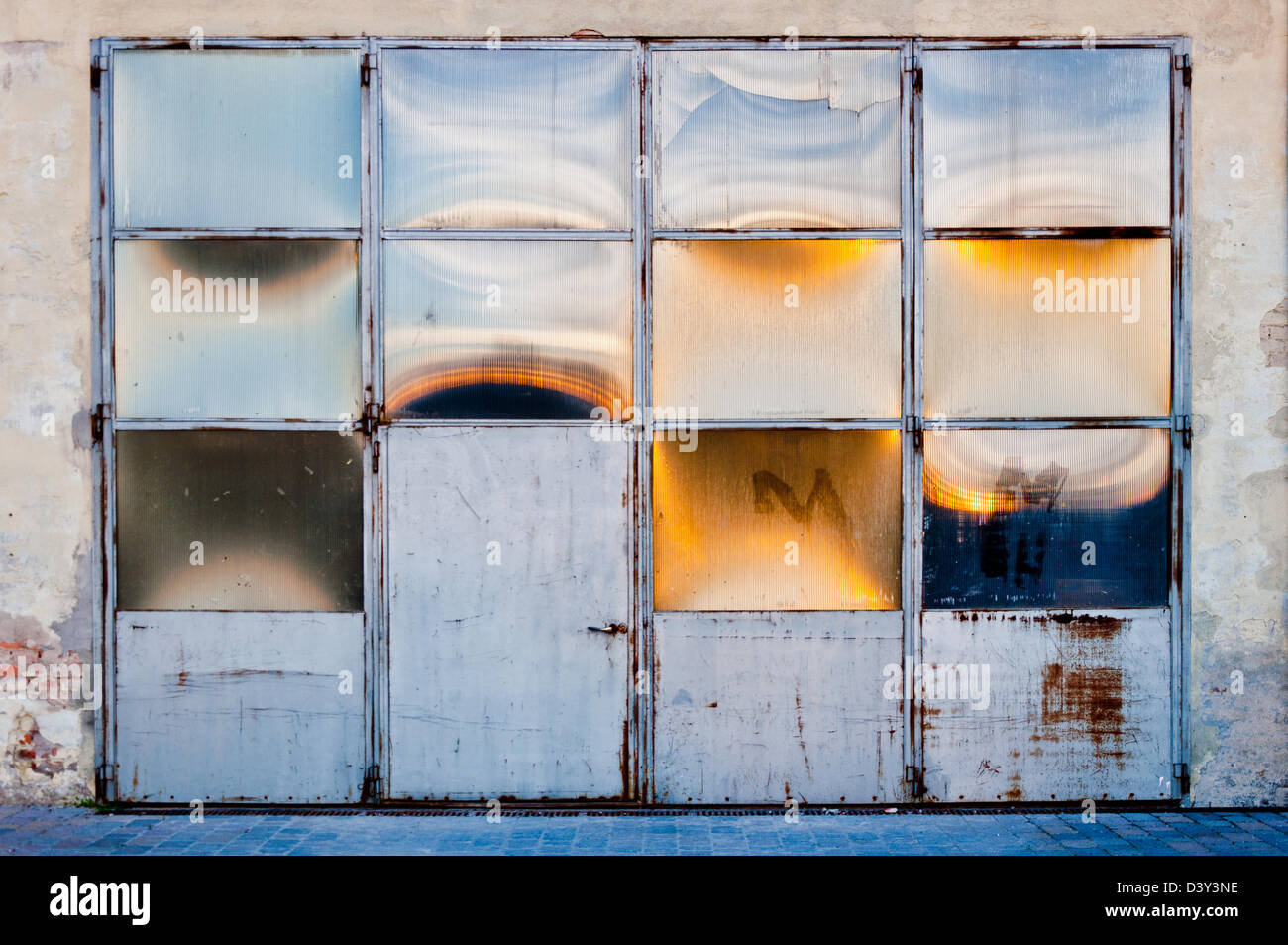 Old metal and glass warehouse door with sun reflections Stock Photo - Alamy