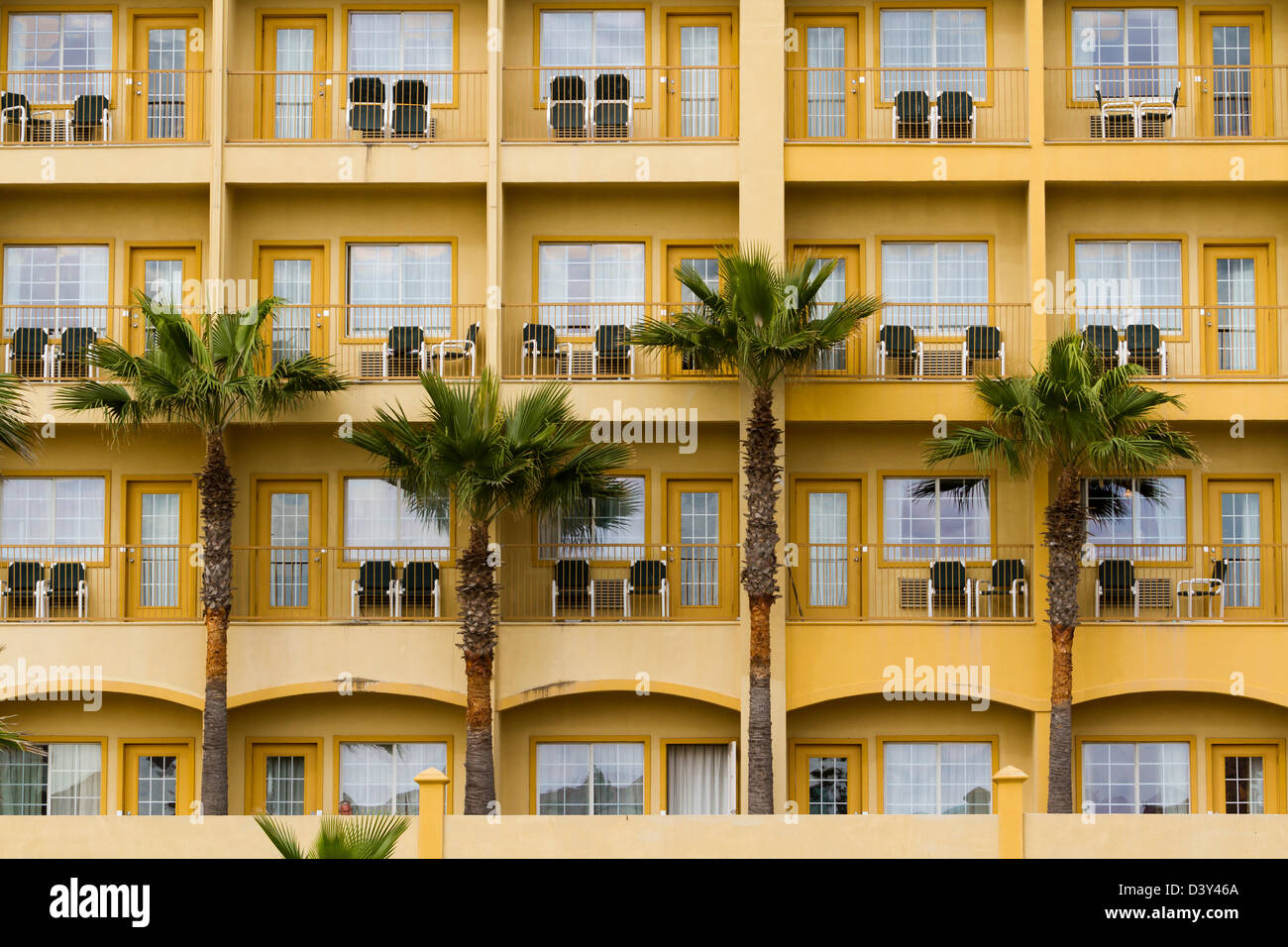 Yellow hotel with balconies Stock Photo - Alamy