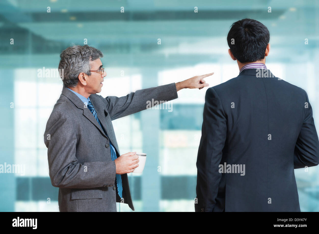 Businessman giving direction to his colleague Stock Photo - Alamy