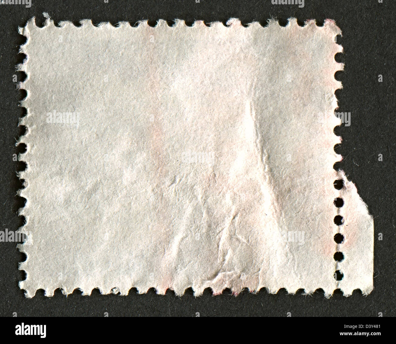The reverse side of a postage stamp Stock Photo - Alamy