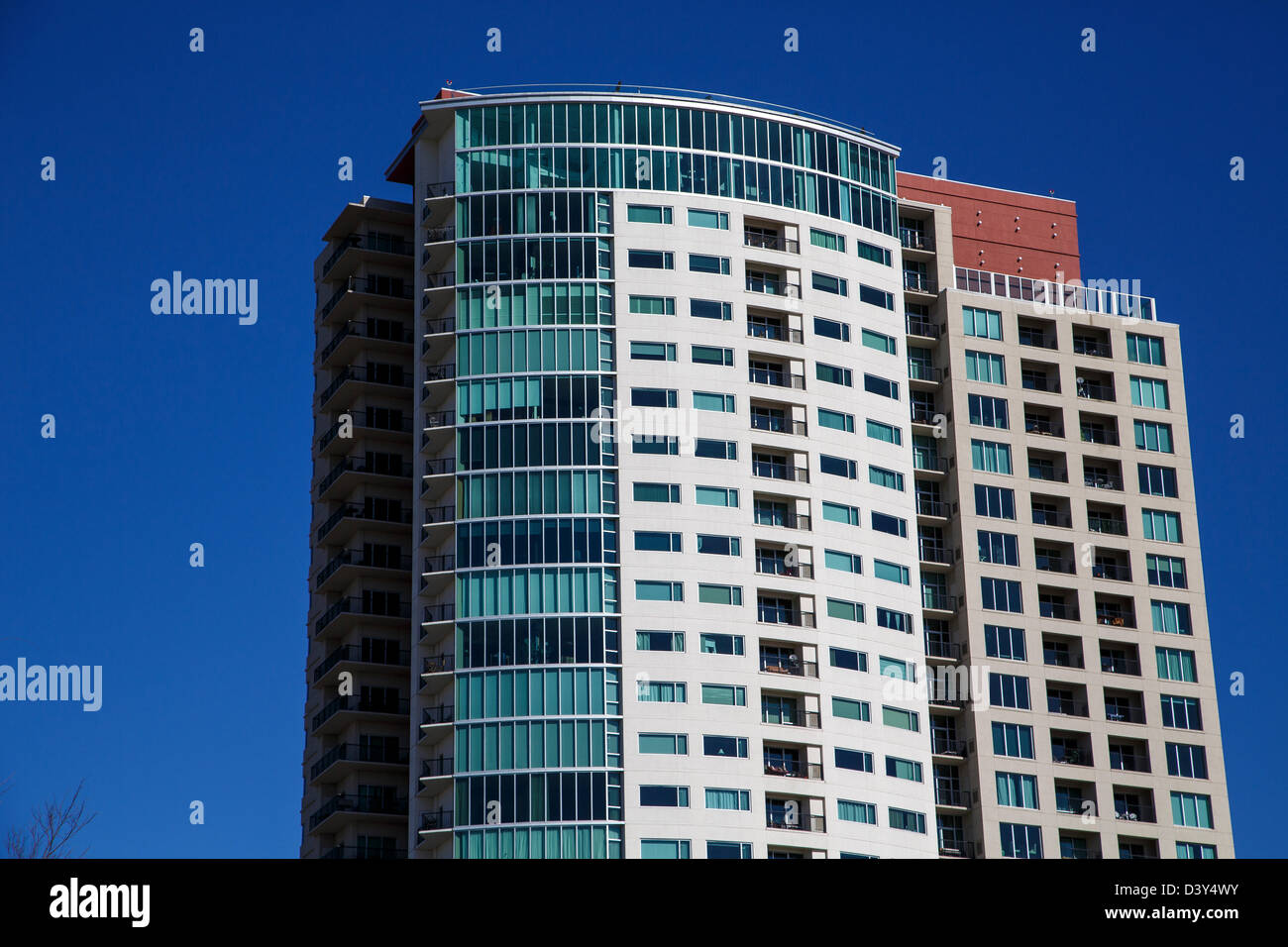 A modern high rise condominium tower rising into a clear blue sky Stock ...