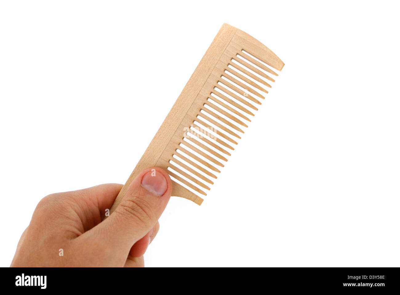 Wooden comb in the hand Stock Photo - Alamy