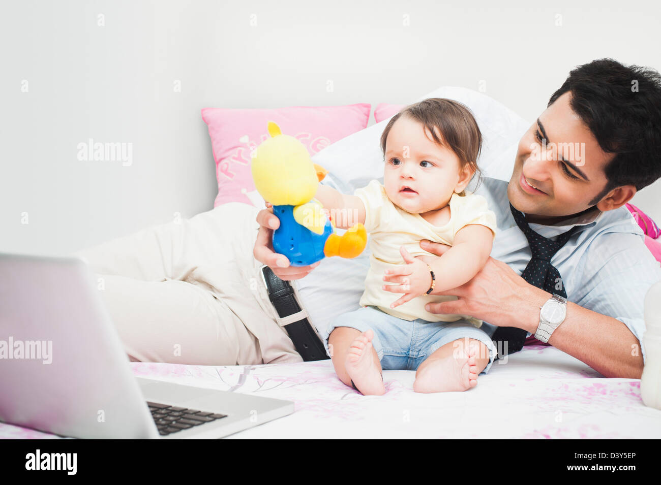 Businessman playing with his baby Stock Photo - Alamy