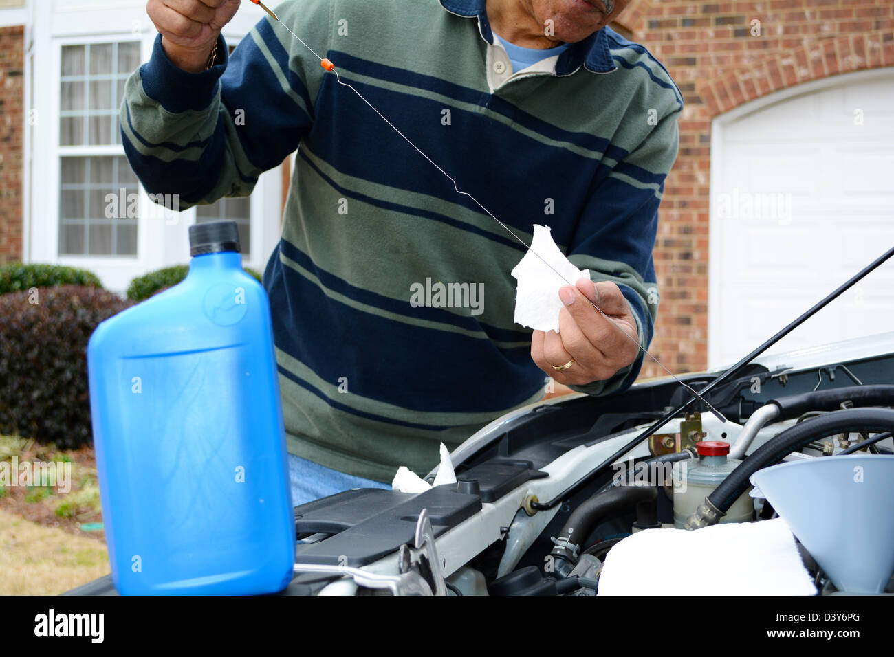 Mechanic working on a car in his driveway Stock Photo - Alamy