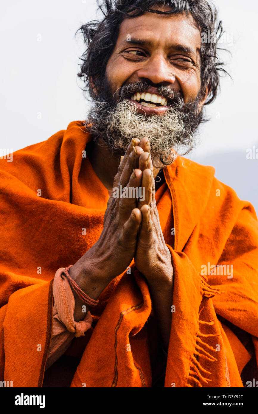 Hindu Sadhu in saffron robe doing namaste gesture and smiling Stock ...