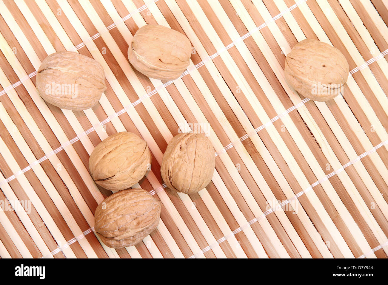 Some walnuts on a bamboo background Stock Photo - Alamy