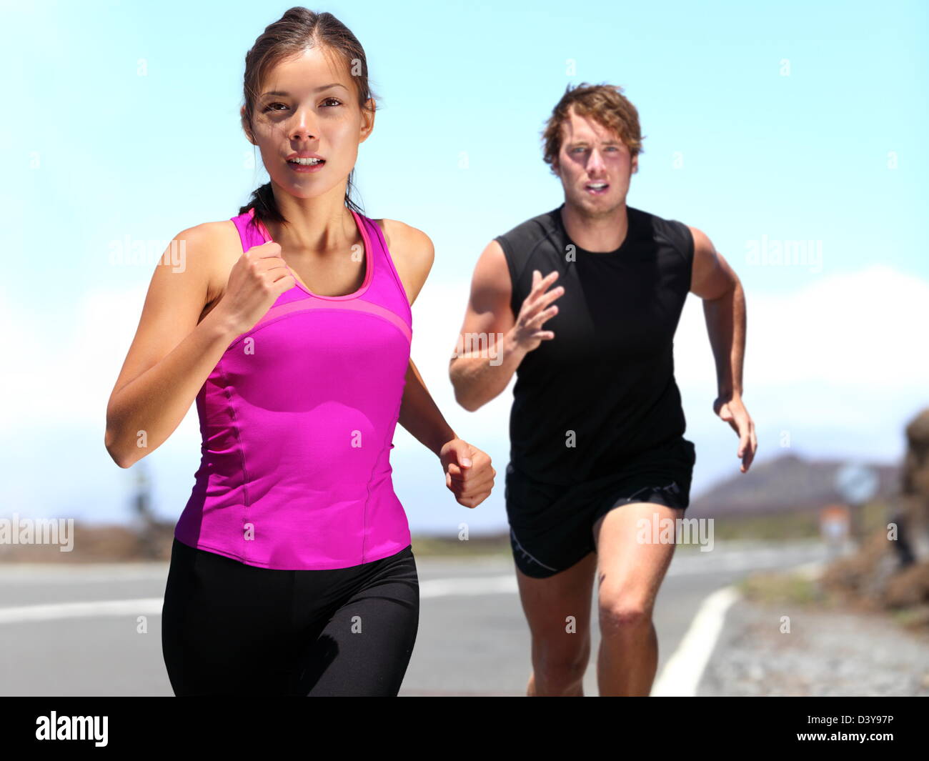 Young Caucasian man and beautiful Asian woman running training for ...