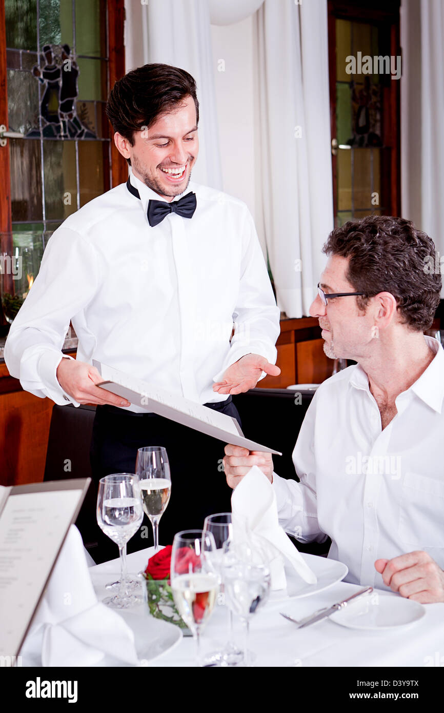man and woman in restaurant waiter bring card and order food Stock ...