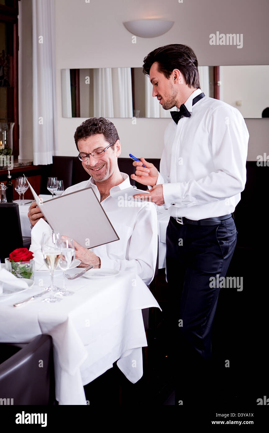 man and woman in restaurant waiter bring card and order food Stock ...