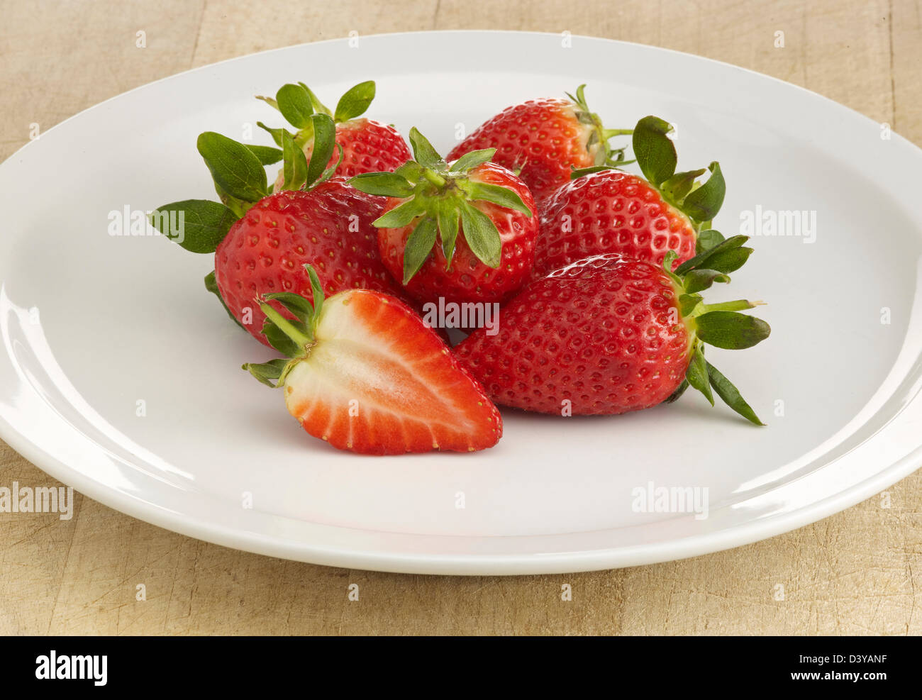 Strawberry on white plate Stock Photo - Alamy