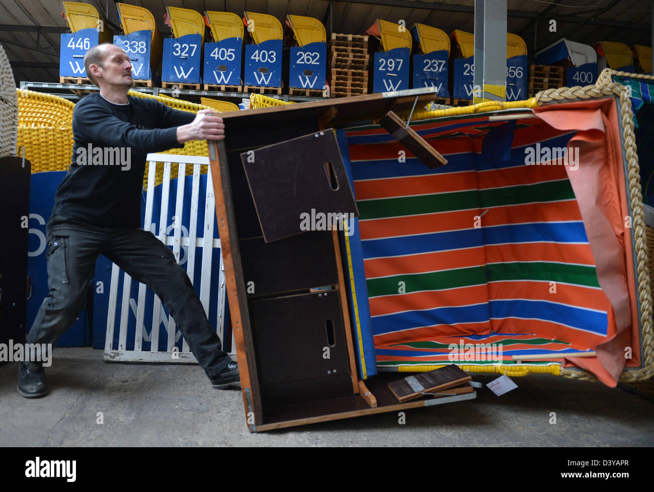 Matthias Hild-Baack, owner of a beach chair rental company, rights a ...