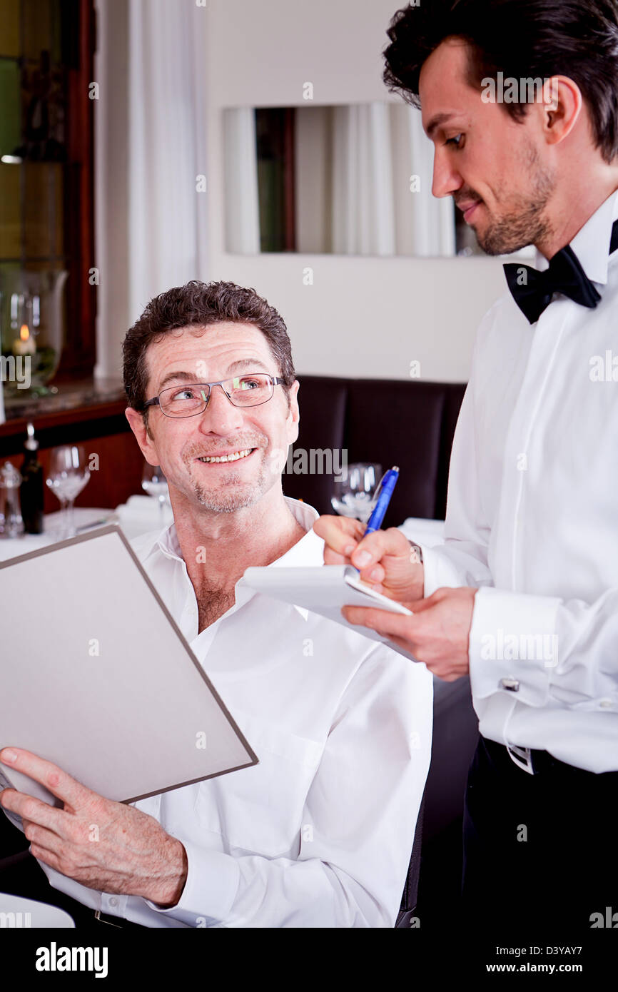 man and woman in restaurant waiter bring card and order food Stock ...