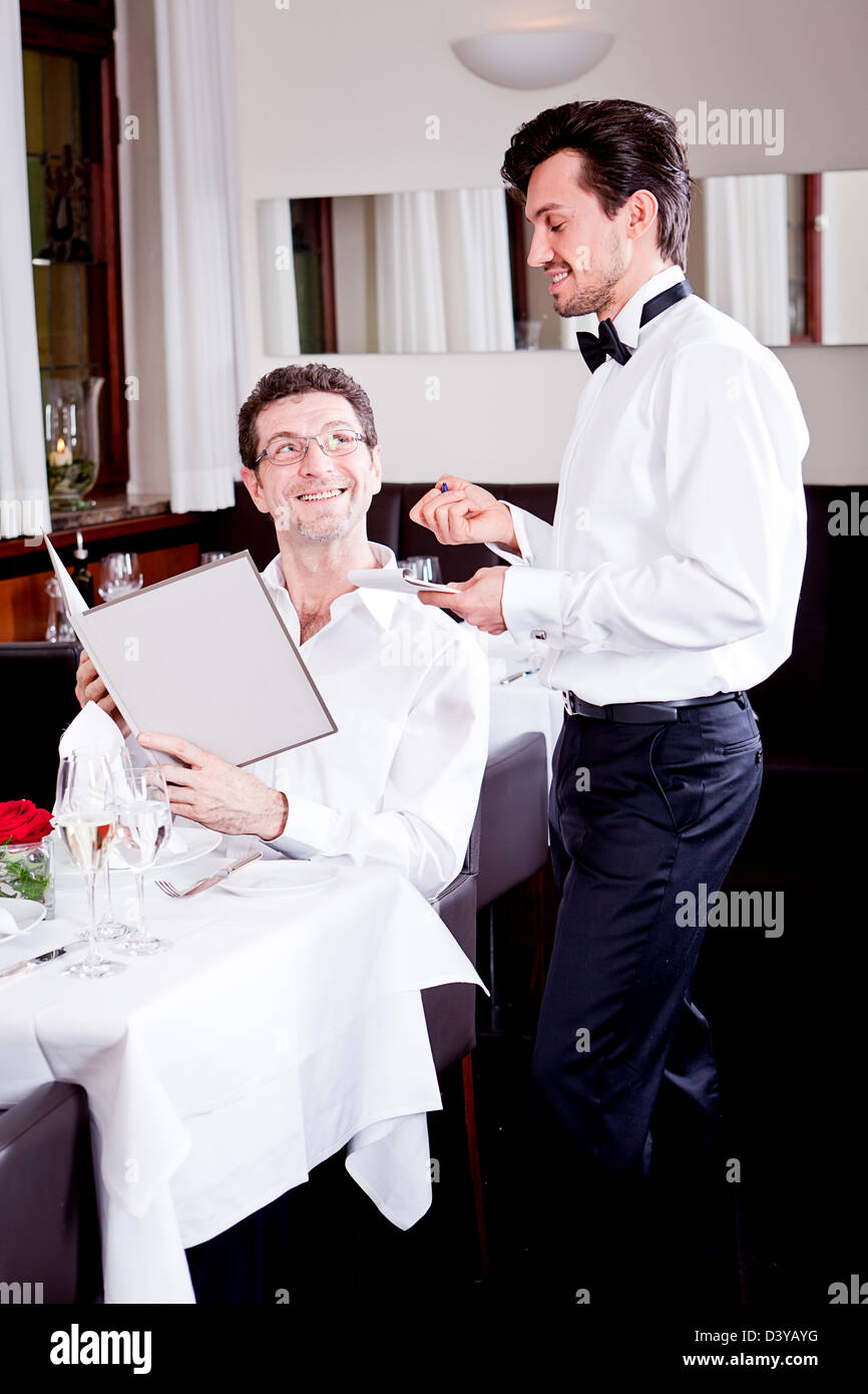 man and woman in restaurant waiter bring card and order food Stock ...