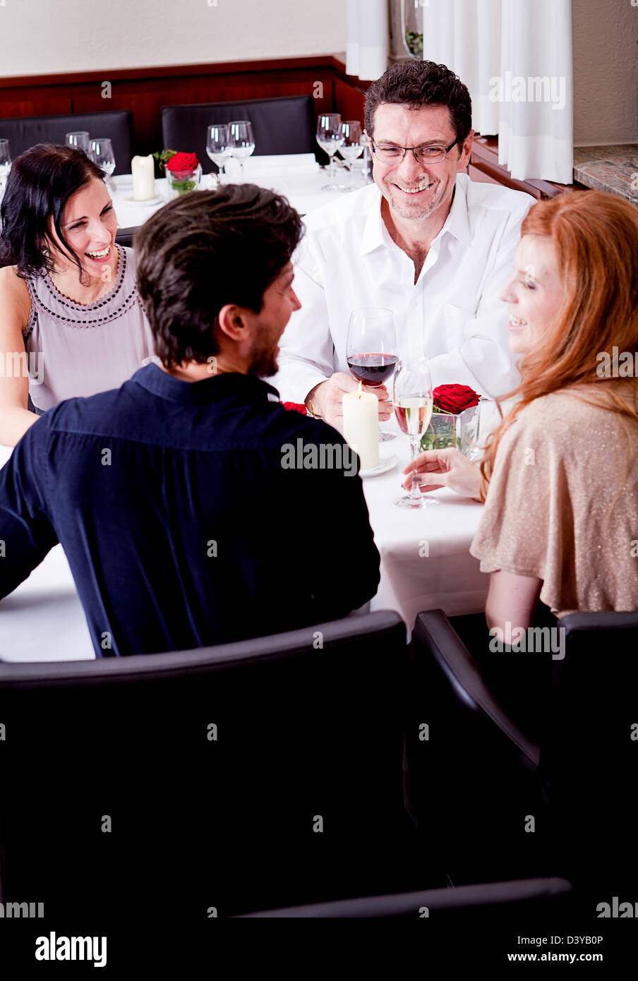 smiling happy people in restaurant drinking talking having fun Stock ...