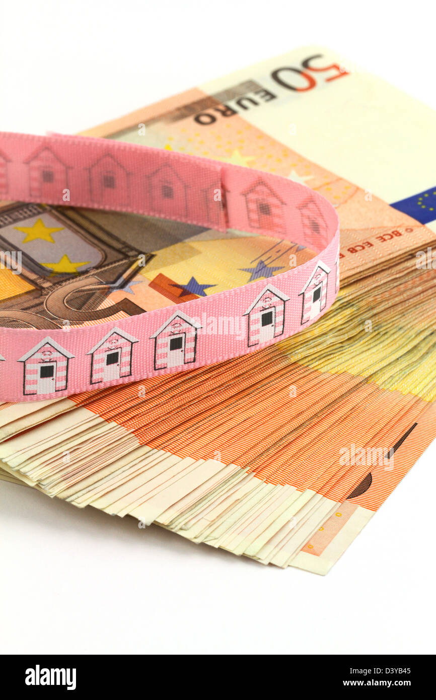 Stack of banknotes and houses on ribbon Stock Photo - Alamy