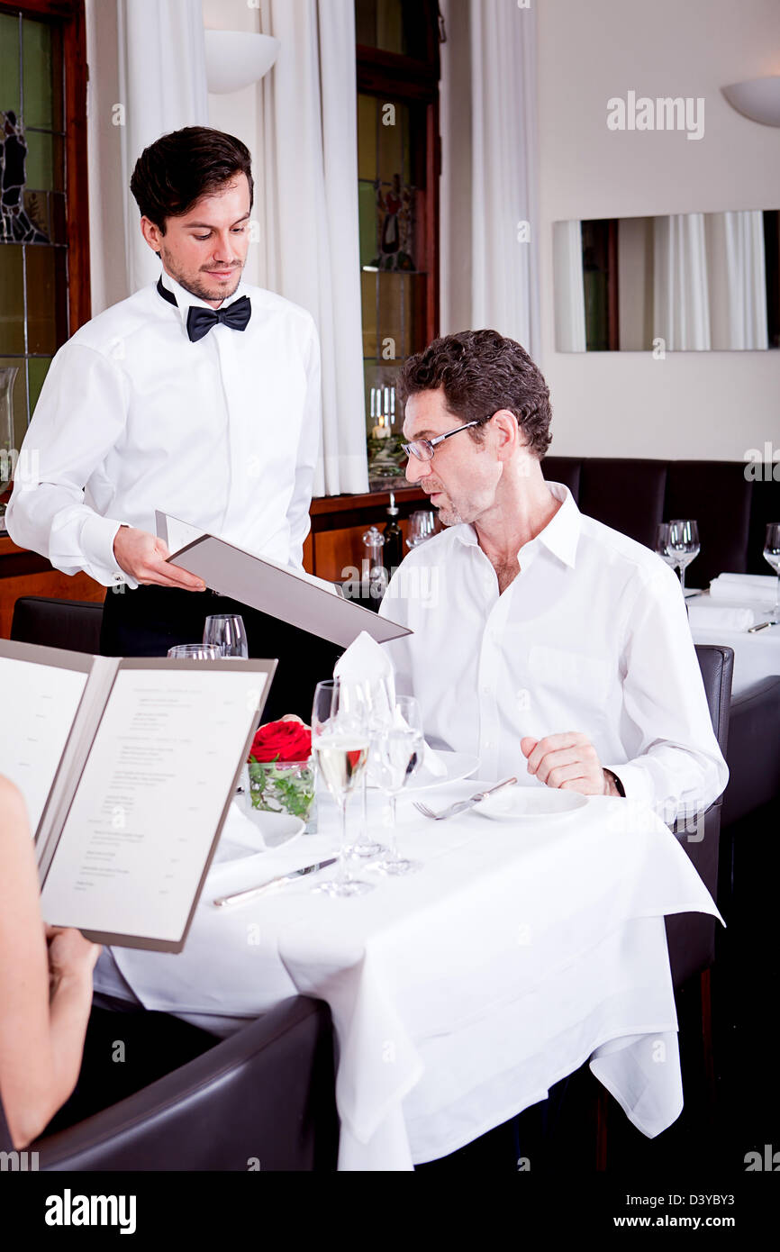 man and woman in restaurant waiter bring card and order food Stock ...