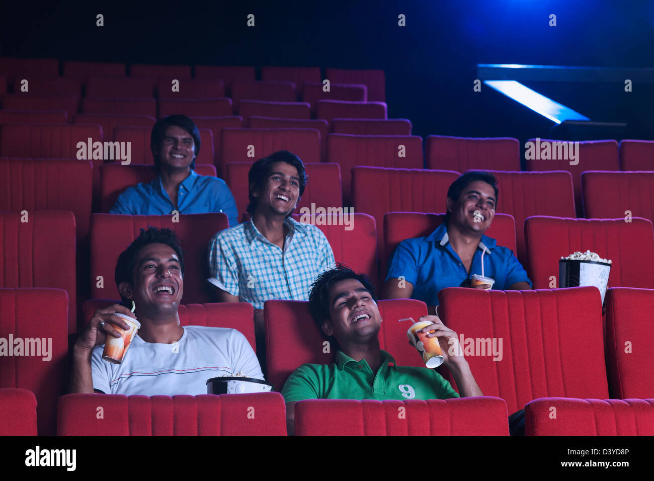 Youngsters enjoying movie in a cinema hall Stock Photo - Alamy