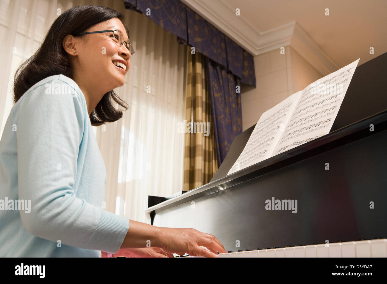 Chinese woman playing piano Stock Photo - Alamy