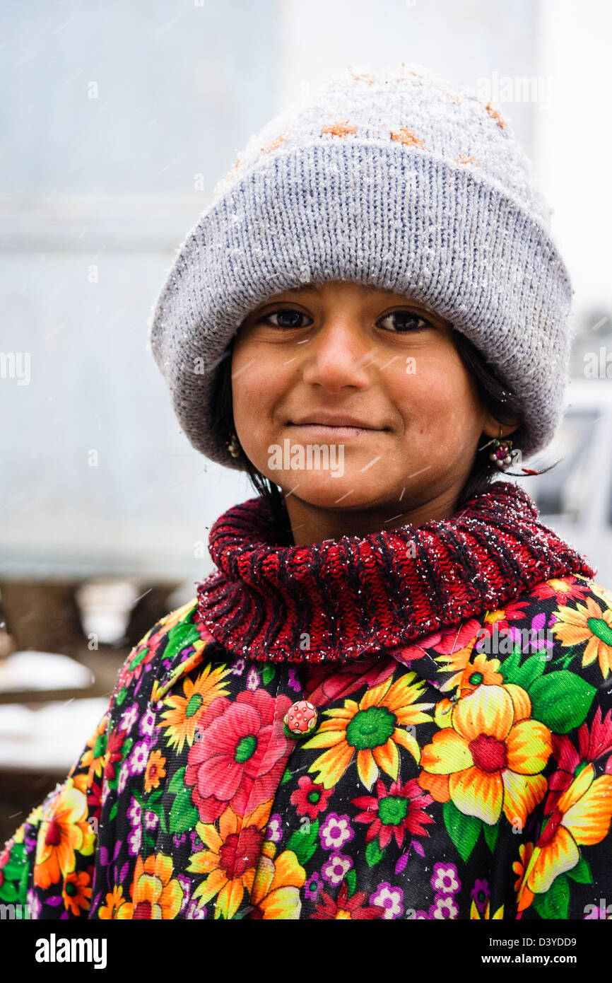Colorful portrait of Uzbek little girl on a snowy day. Samarkand ...