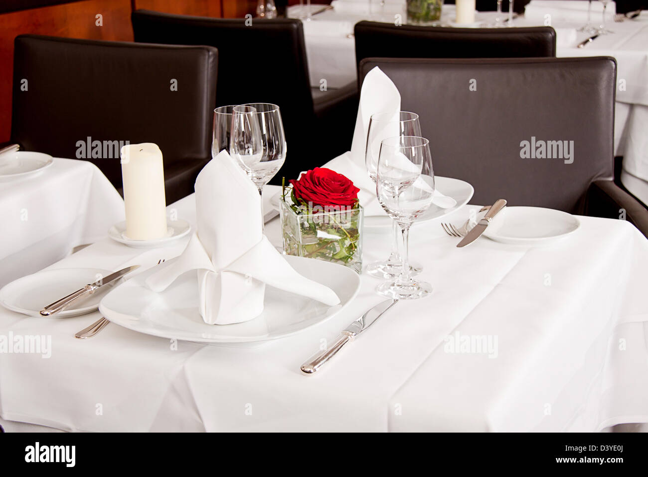tables in restaurant with white tablecloth and elegant dish and ...