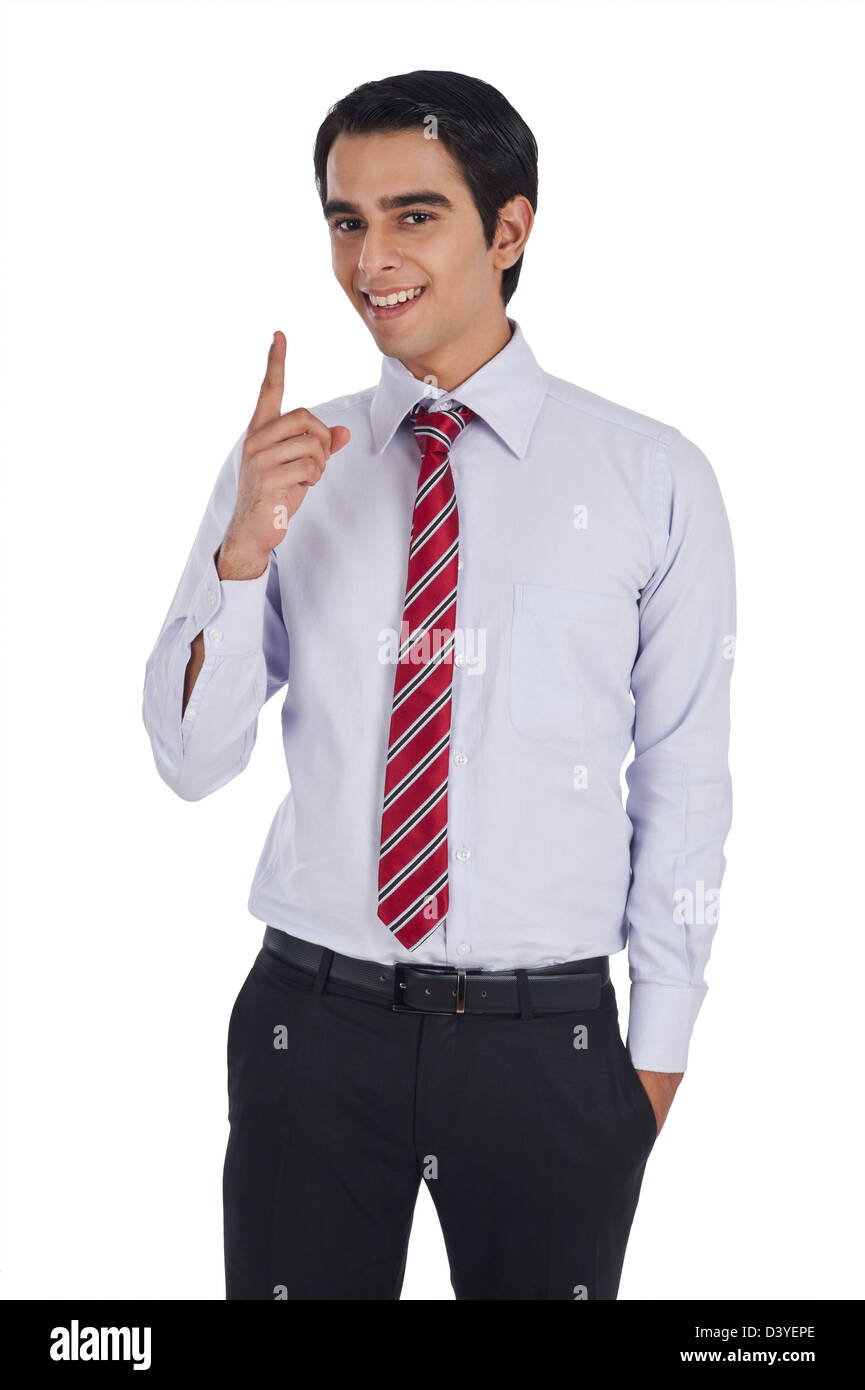 Portrait of a businessman pointing and smiling Stock Photo - Alamy