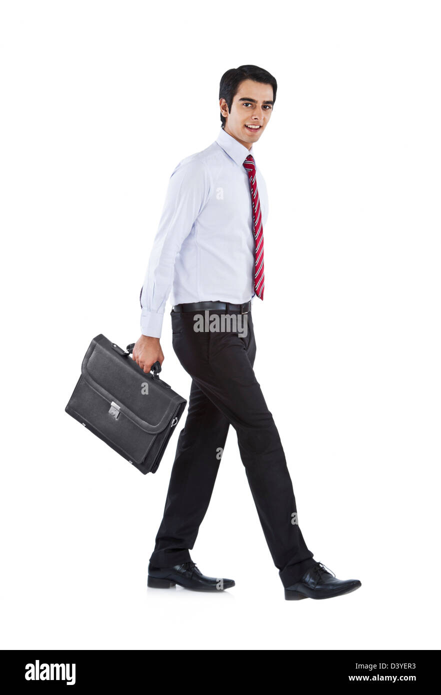 Businessman carrying a briefcase and smiling Stock Photo - Alamy