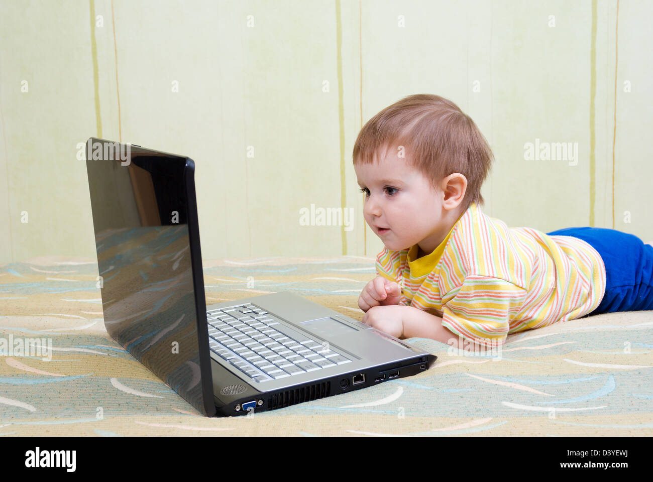 Small baby with laptop .Baby with surprised express working on laptop ...