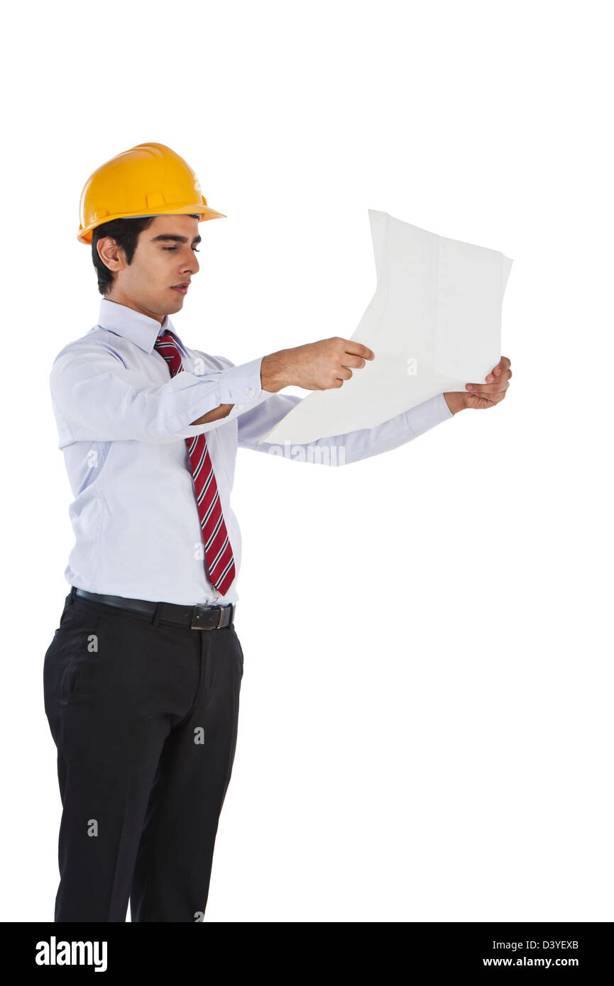 Male architect looking at a blueprint Stock Photo - Alamy