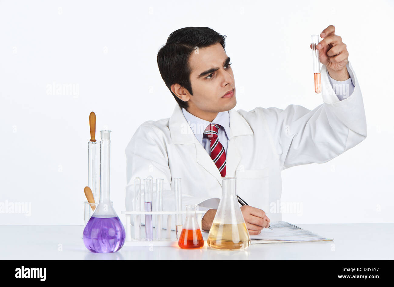 Male scientist doing scientific experiment in a laboratory Stock Photo ...