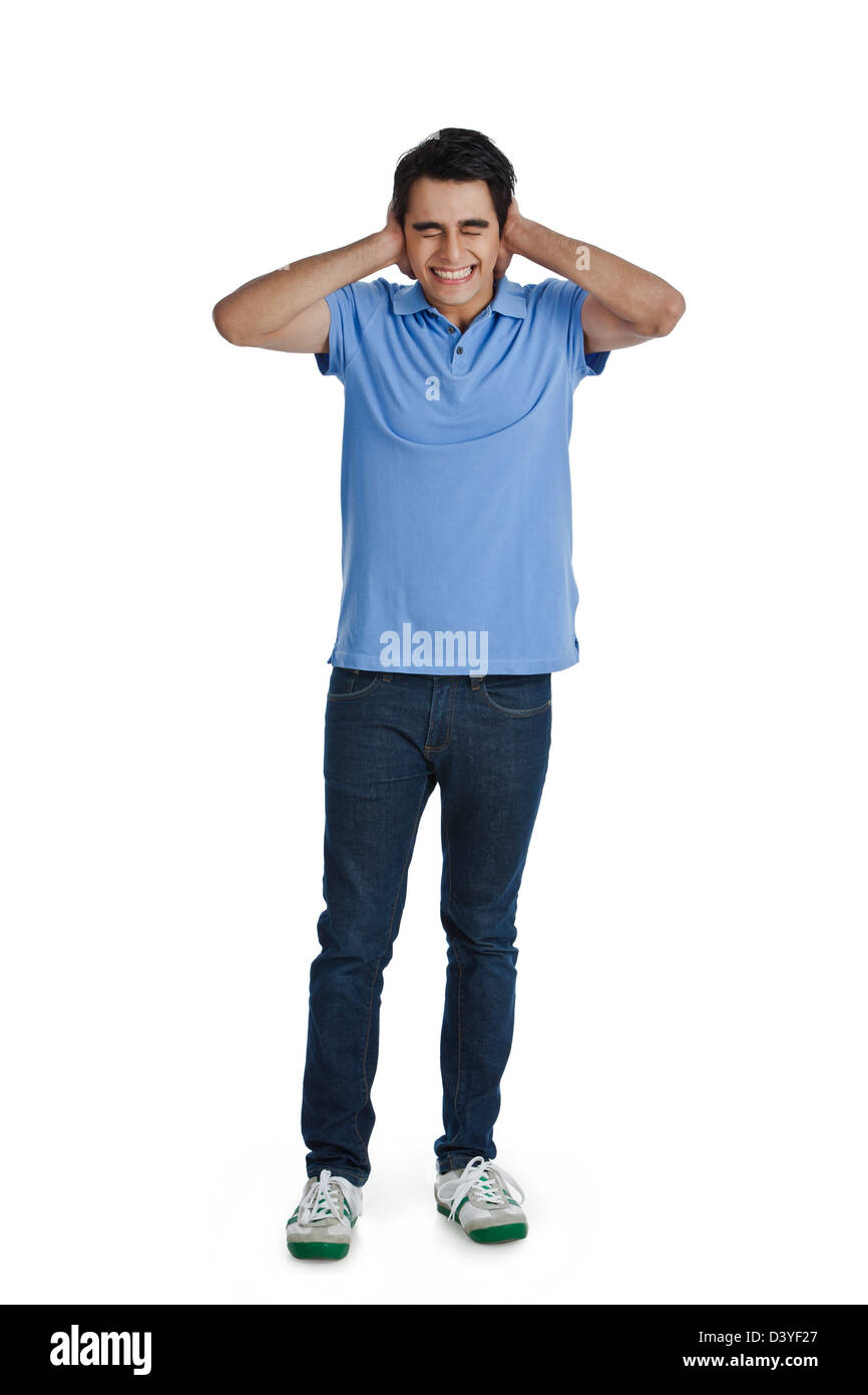 Smiling man covering eyes Cut Out Stock Images & Pictures - Alamy