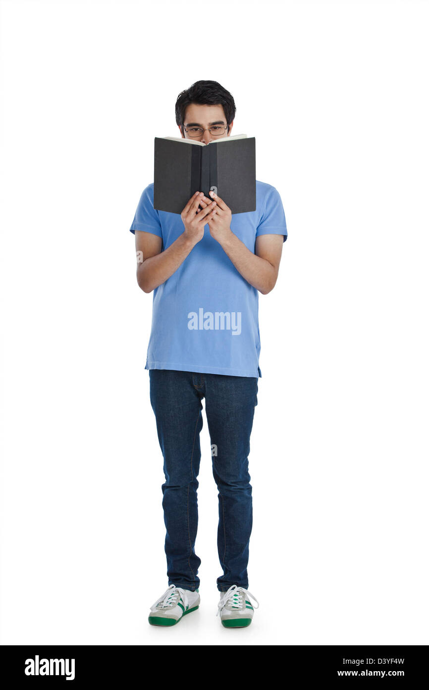 Man standing reading book Cut Out Stock Images & Pictures - Alamy