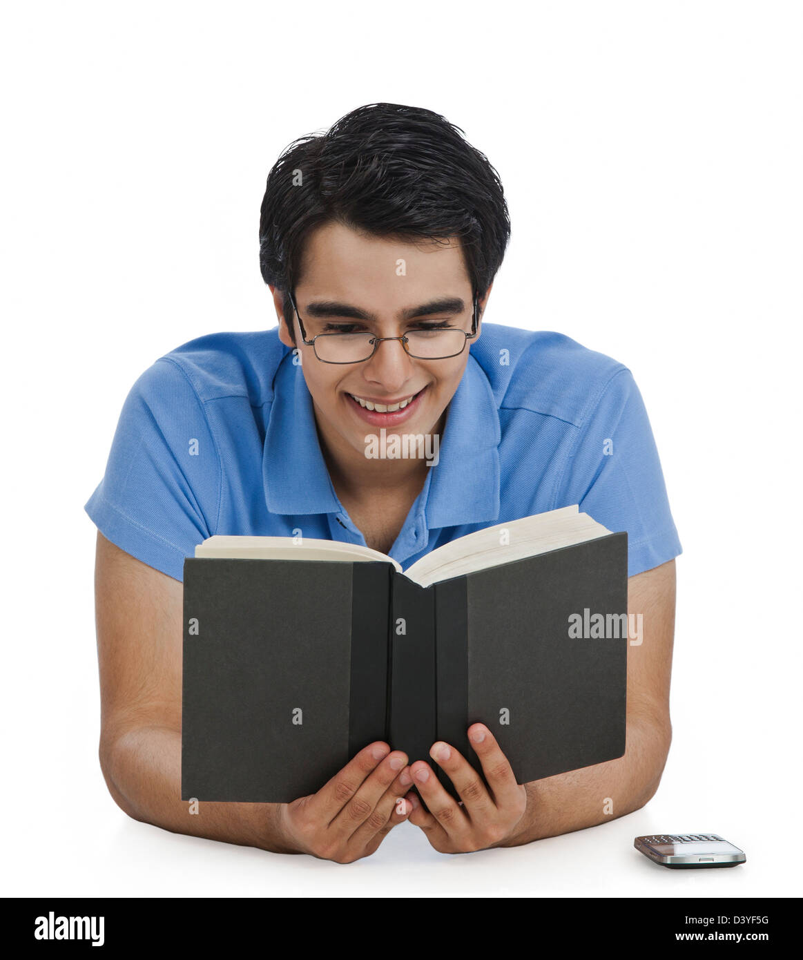 Happy man lying on the floor and reading a book Stock Photo - Alamy