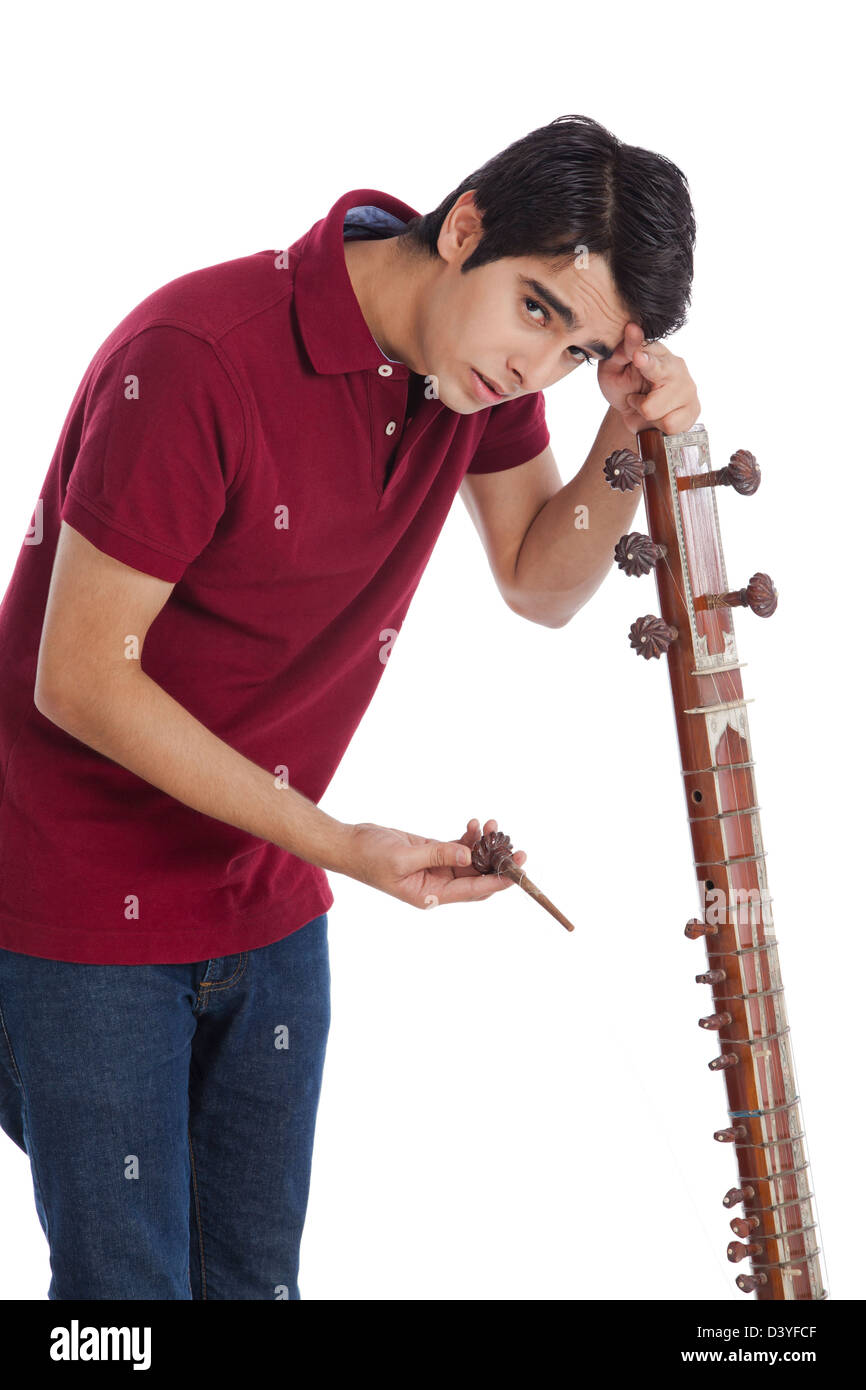 Man leaning over his broken sitar Stock Photo - Alamy