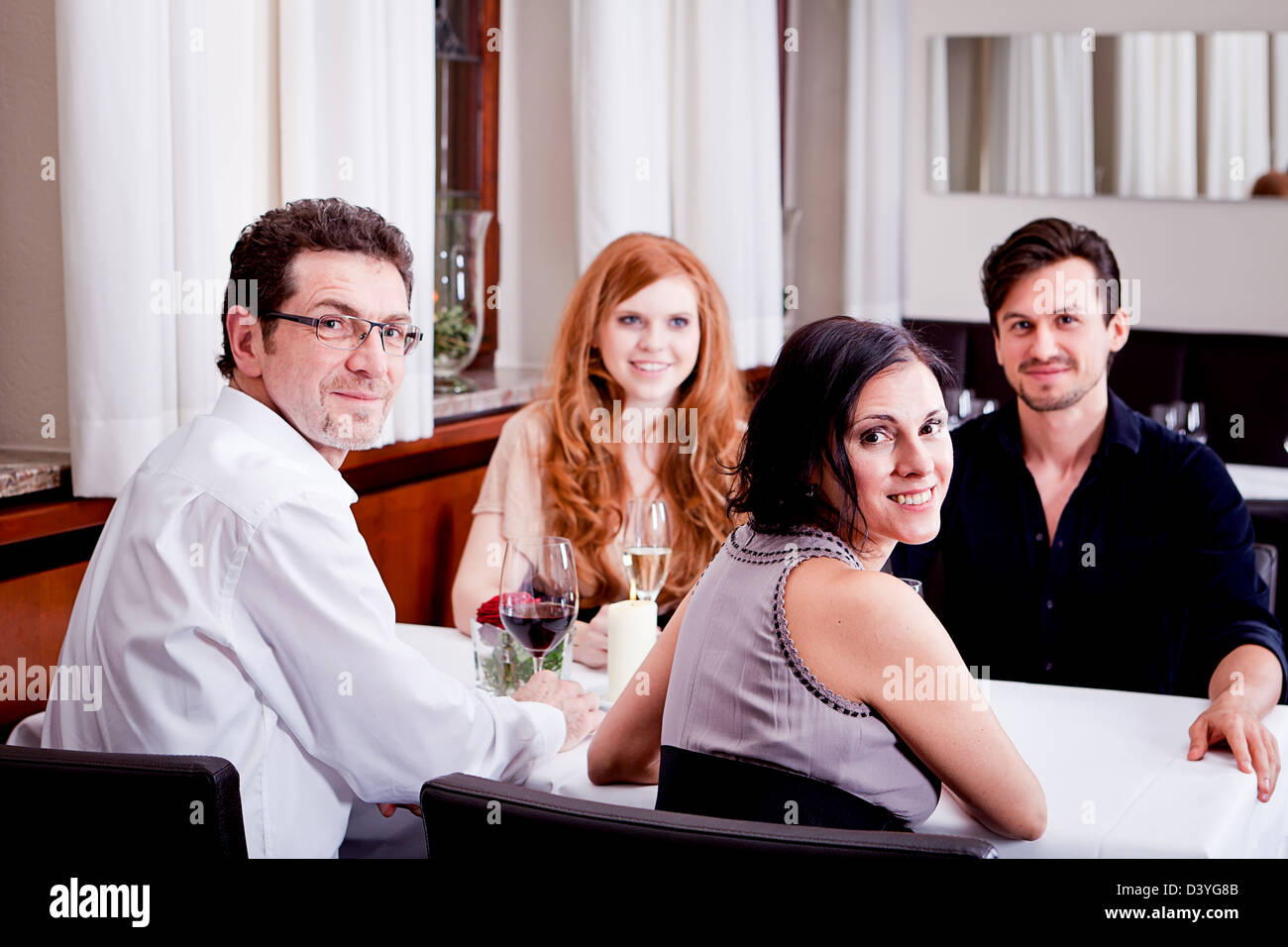 smiling happy people in restaurant drinking talking having fun Stock ...