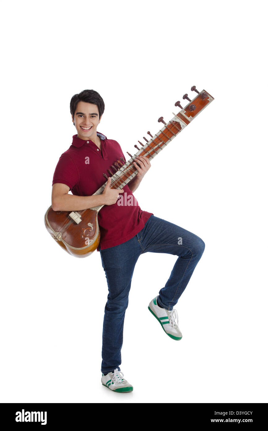 Man playing a sitar and smiling Stock Photo - Alamy