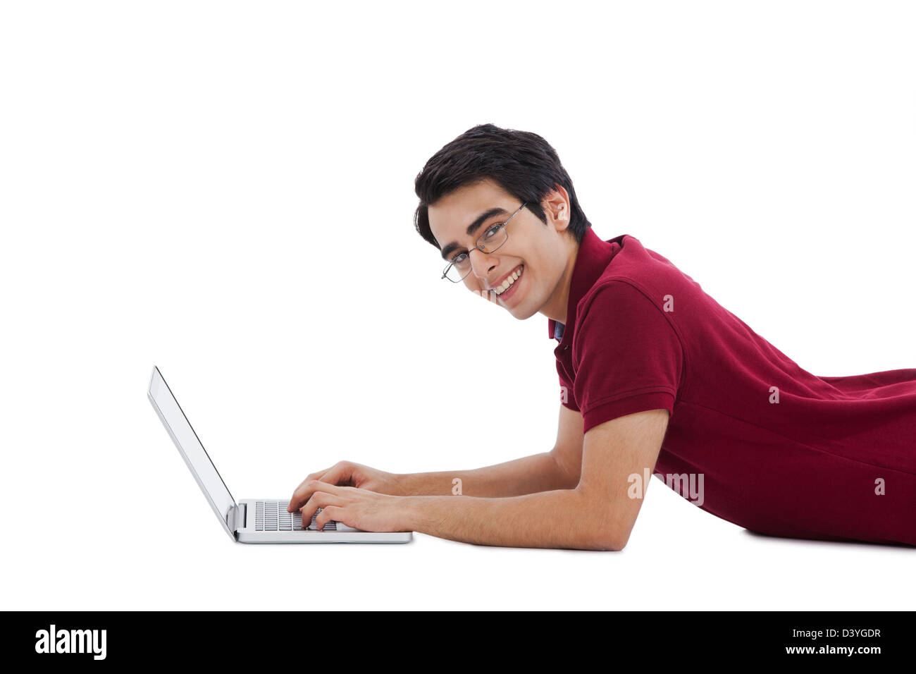 Happy man lying on the floor and using a laptop Stock Photo - Alamy