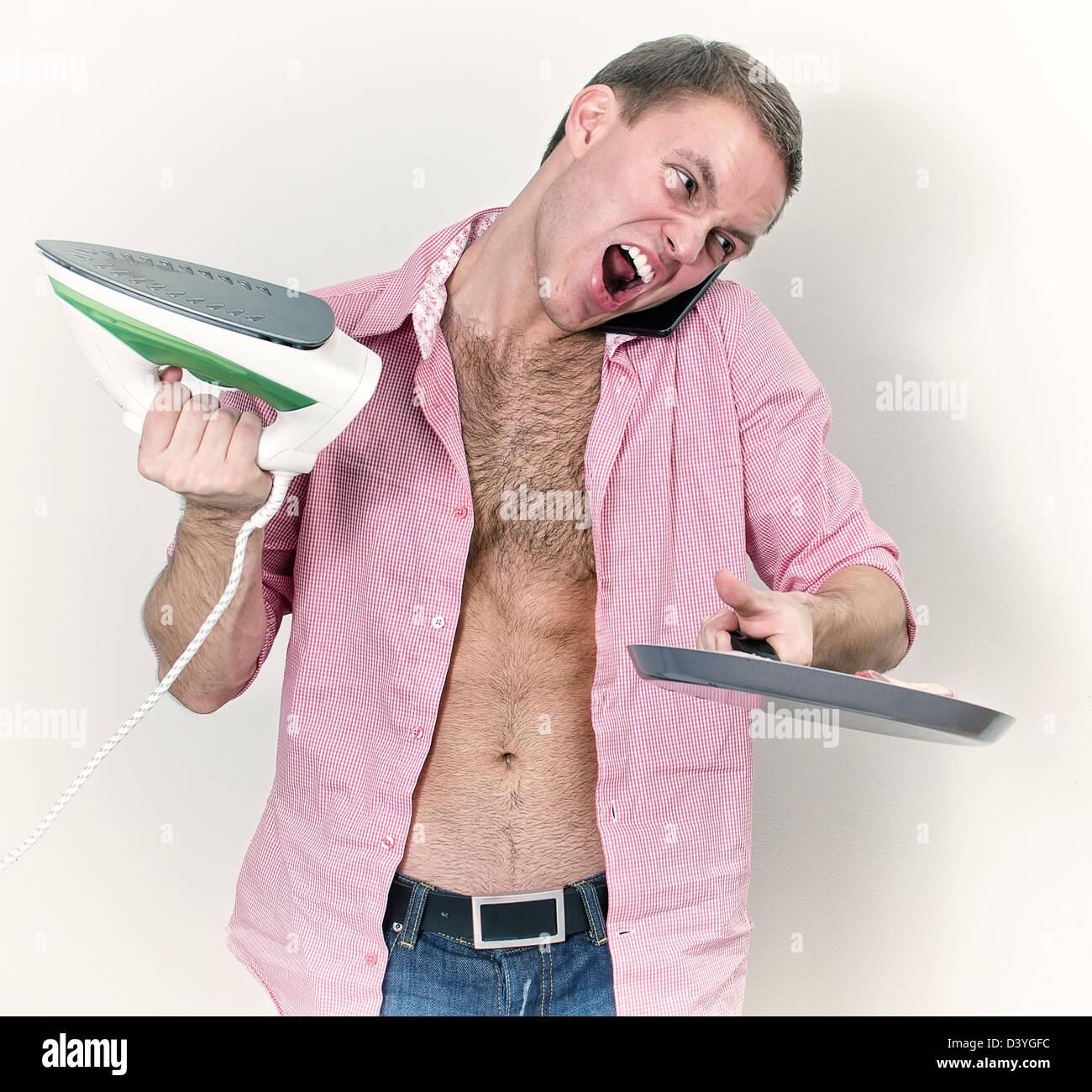 Young man with pan and iron speaking on the phone Stock Photo - Alamy